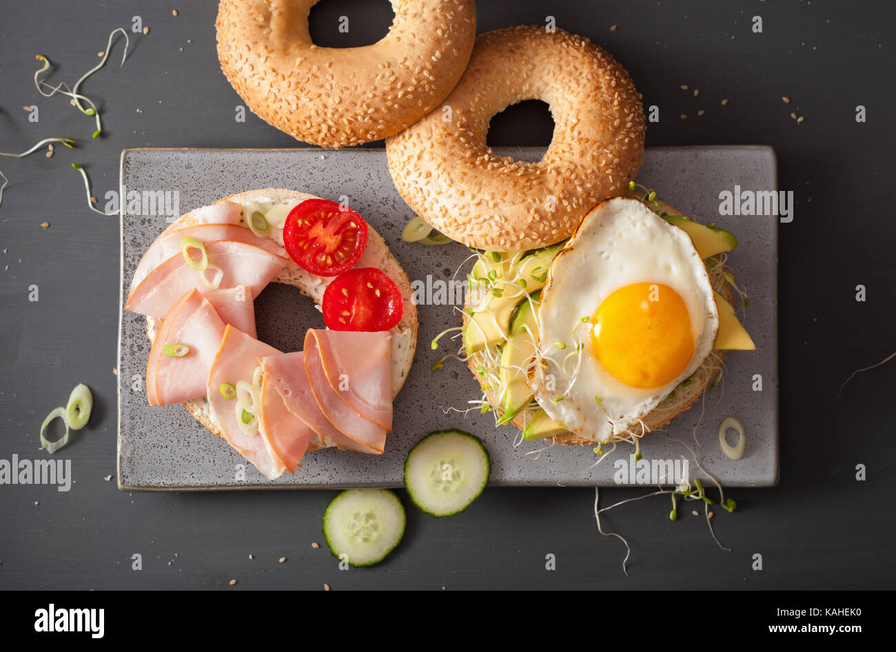 sandwiches on bagels with egg, avocado, soft cheese, alfalfa sprouts ...