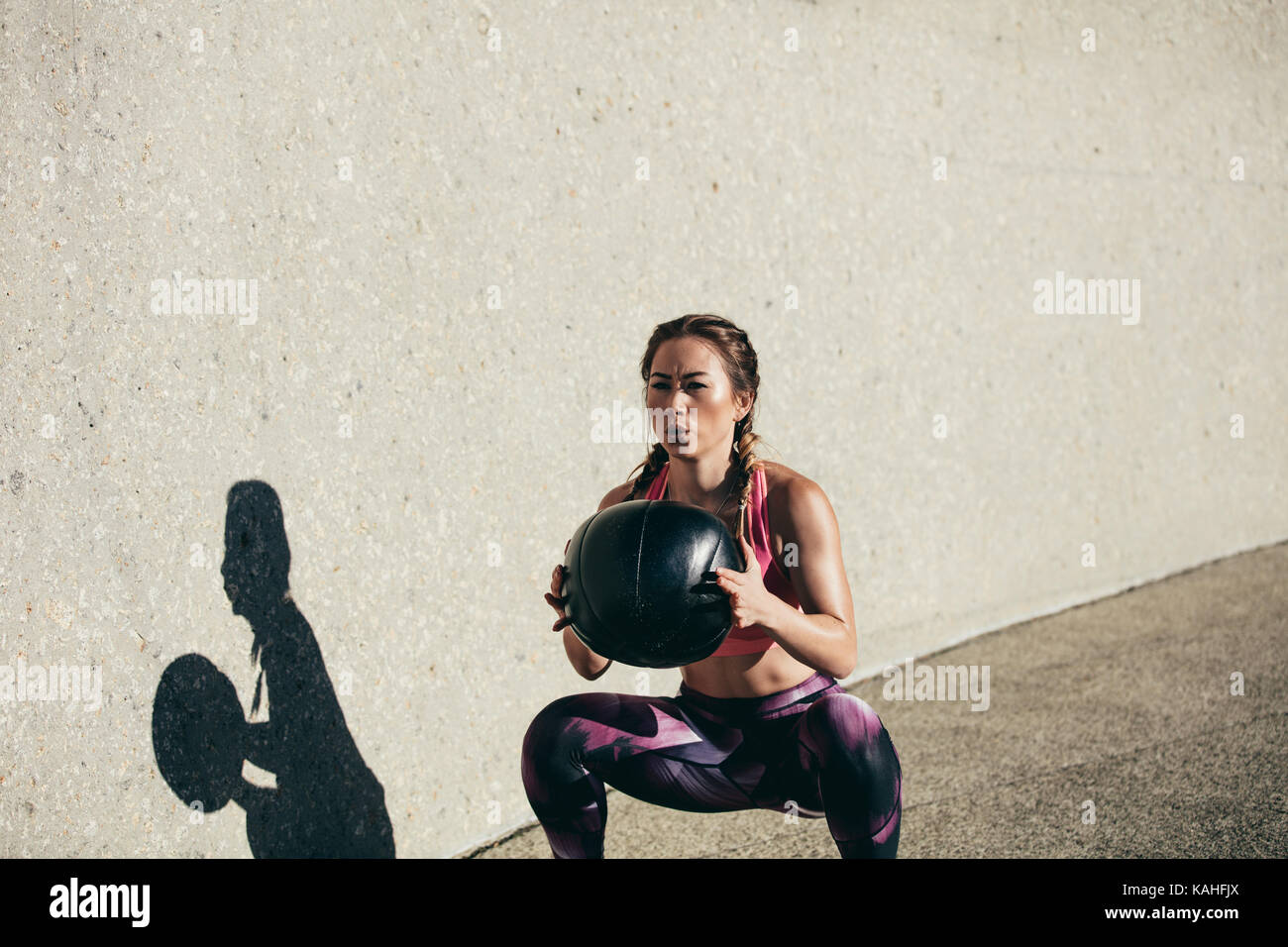 Sportswoman Doing Squat Exercises With Fitness Ball Female Exercising