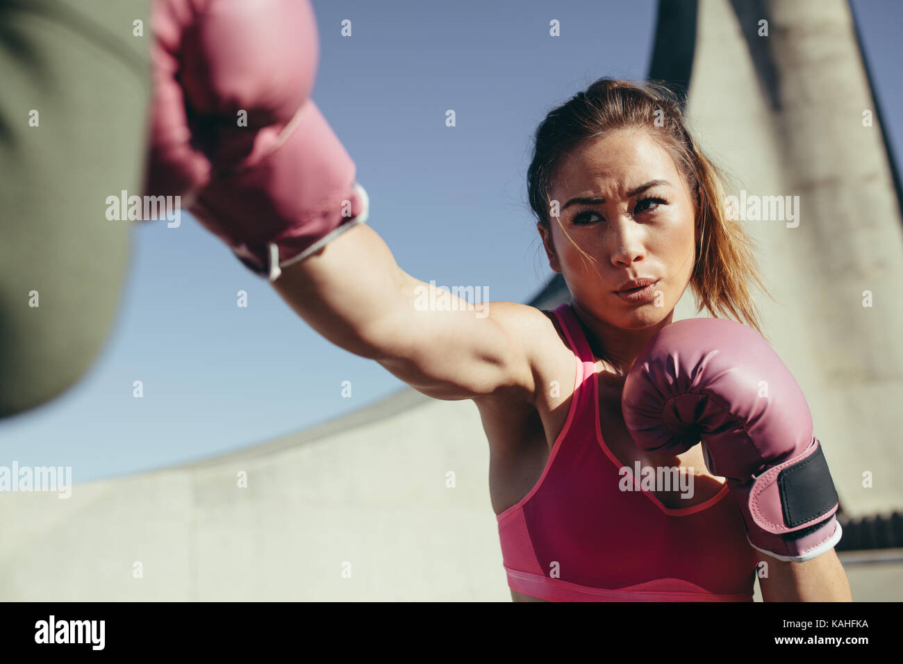 sportswoman wearing boxing gloves training boxing. Strong female ...
