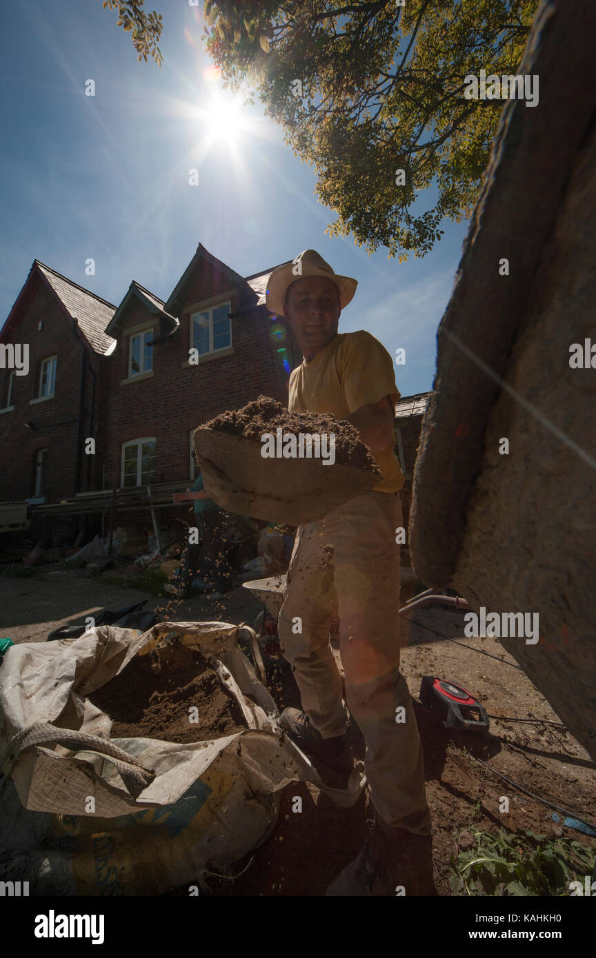 Builder mixing concrete in a petrol-driven mixer Stock Photo - Alamy