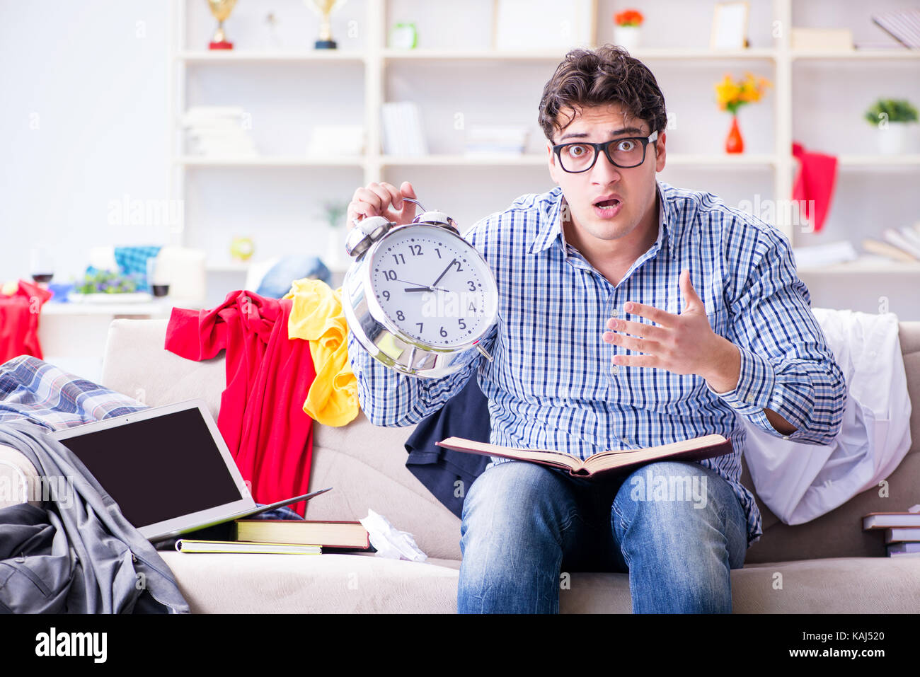 Young man working studying in messy room Stock Photo - Alamy