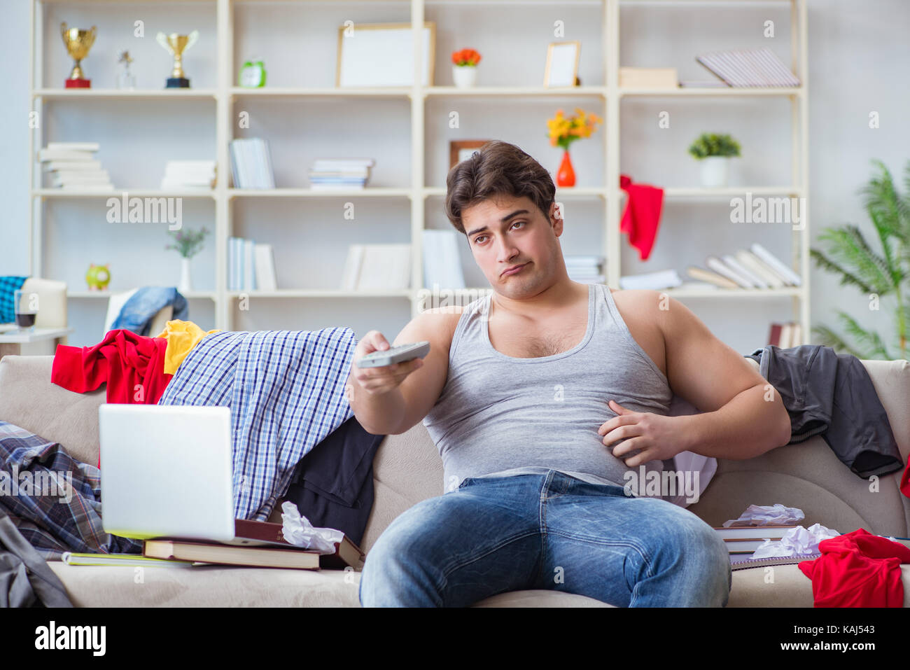 Young man working studying in messy room Stock Photo - Alamy