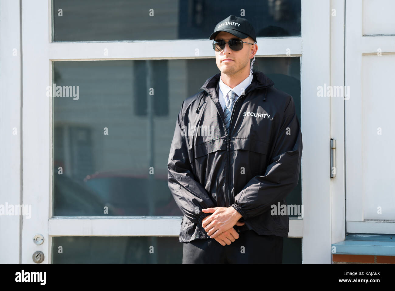 Young Male Security Guard Standing At The Entrance Stock Photo - Alamy
