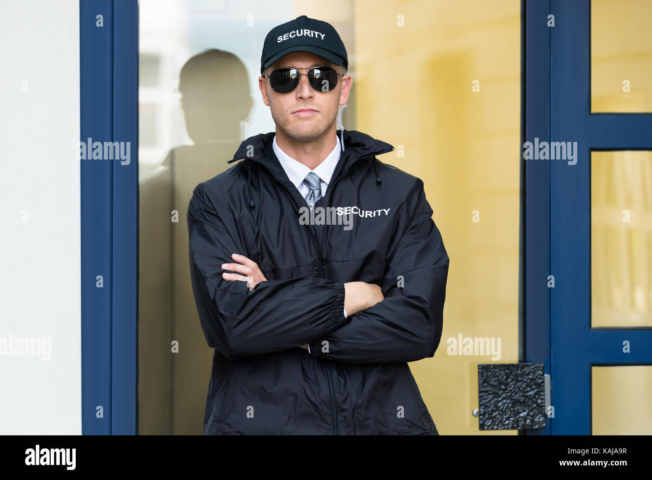 Young Male Security Guard Standing At The Entrance Stock Photo - Alamy