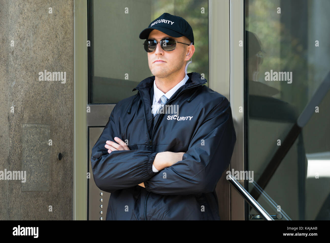 Young Male Security Guard Standing At The Entrance Stock Photo - Alamy