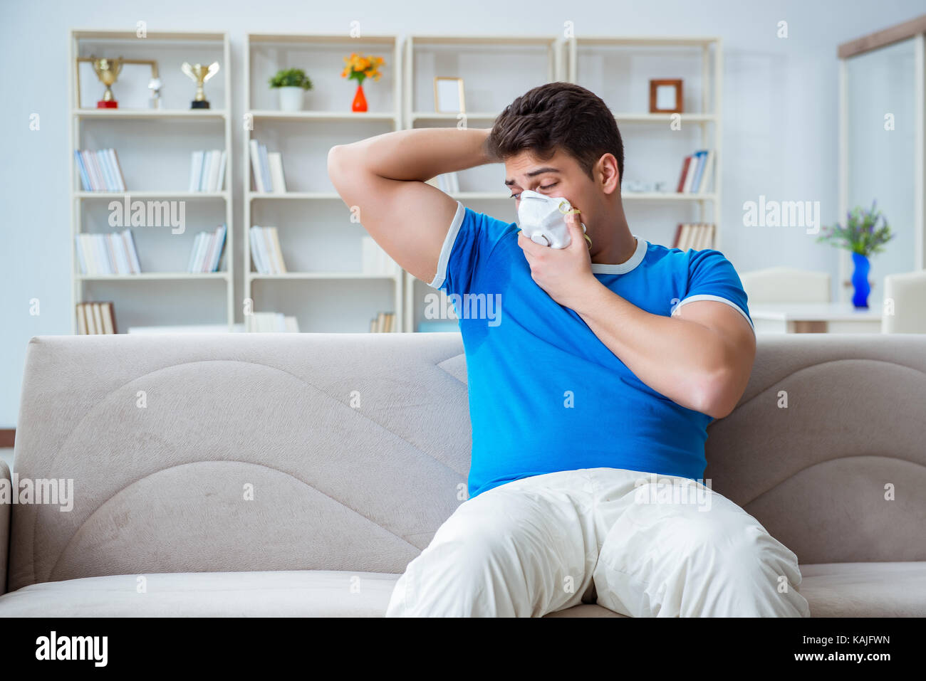 Man sweating excessively smelling bad at home Stock Photo - Alamy