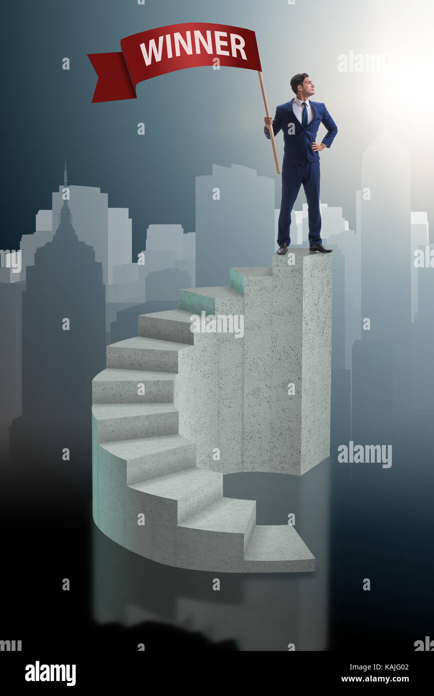 Businessman winner on top of staircase Stock Photo - Alamy