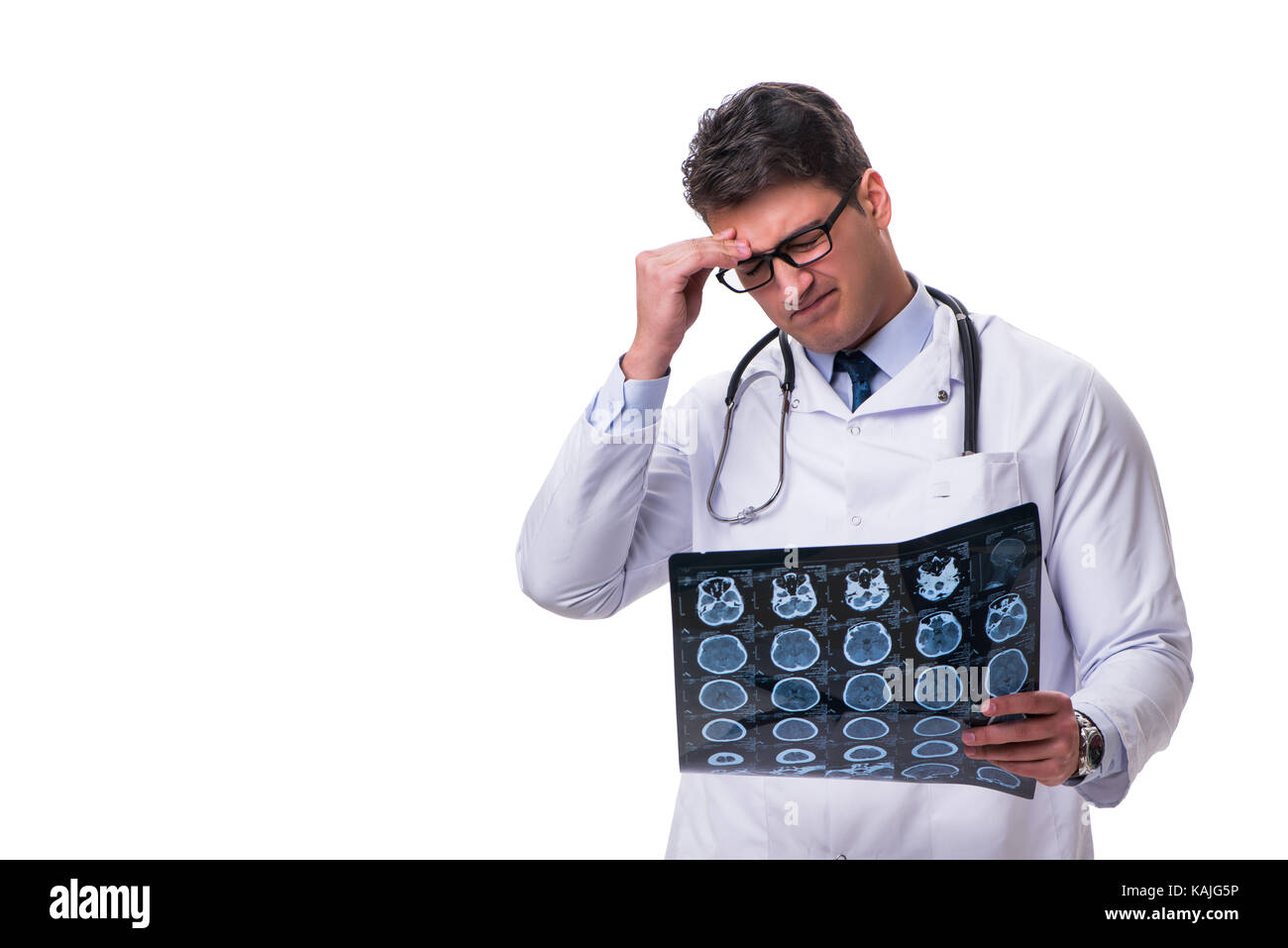 Young male doctor holding a radiograph isolated on white background ...