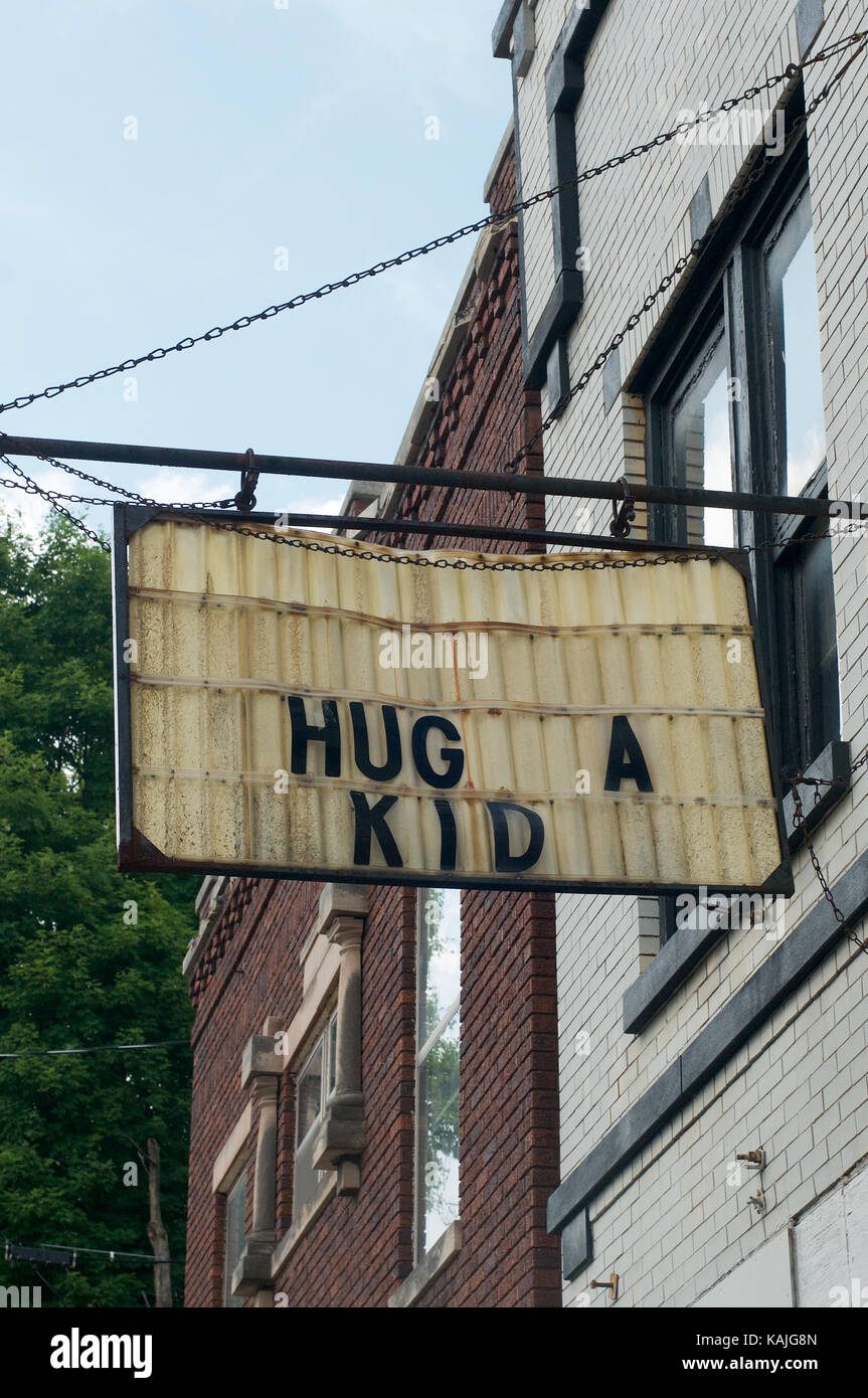 Hug a Kid sign on the side of a building Stock Photo - Alamy