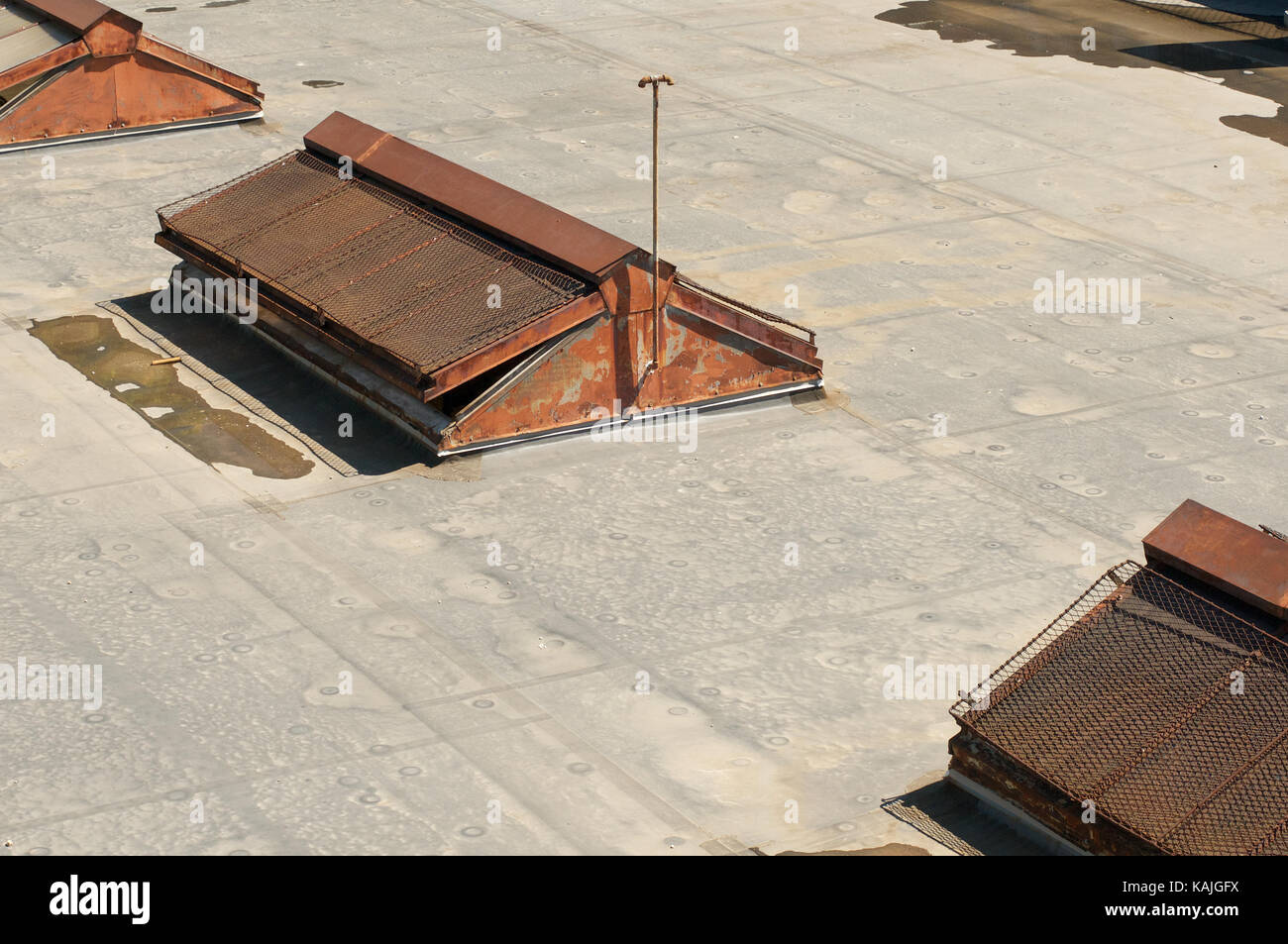 Classic industrial roof vents on top of a building Stock Photo - Alamy