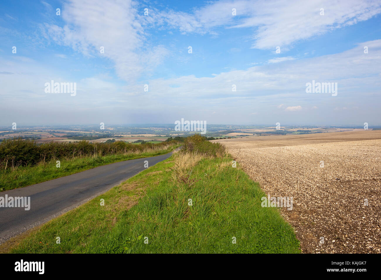 a small country hillside road overlooking scenery in the yorkshire ...