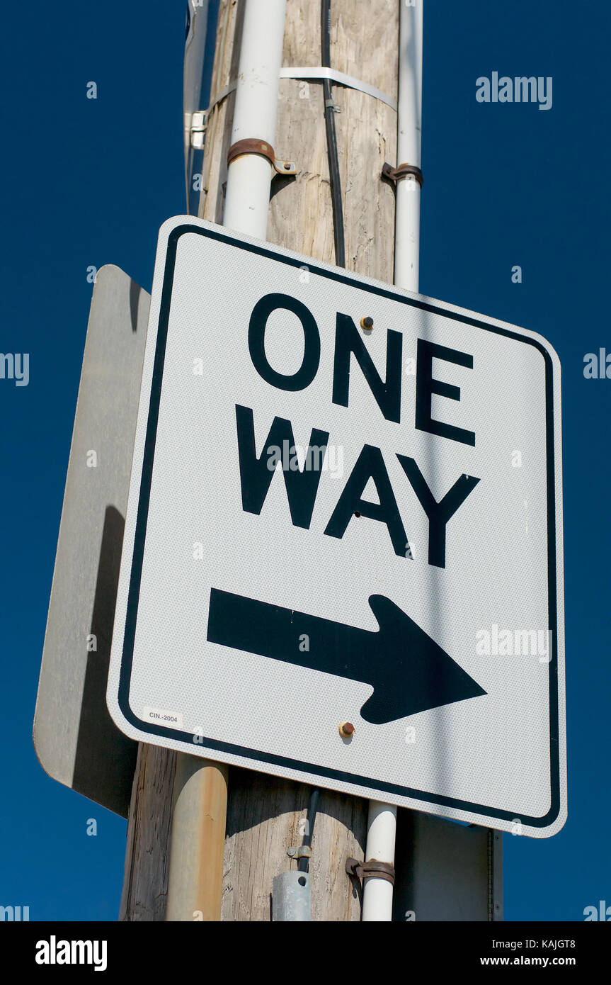 One Way sign on a pole with blue sky Stock Photo - Alamy