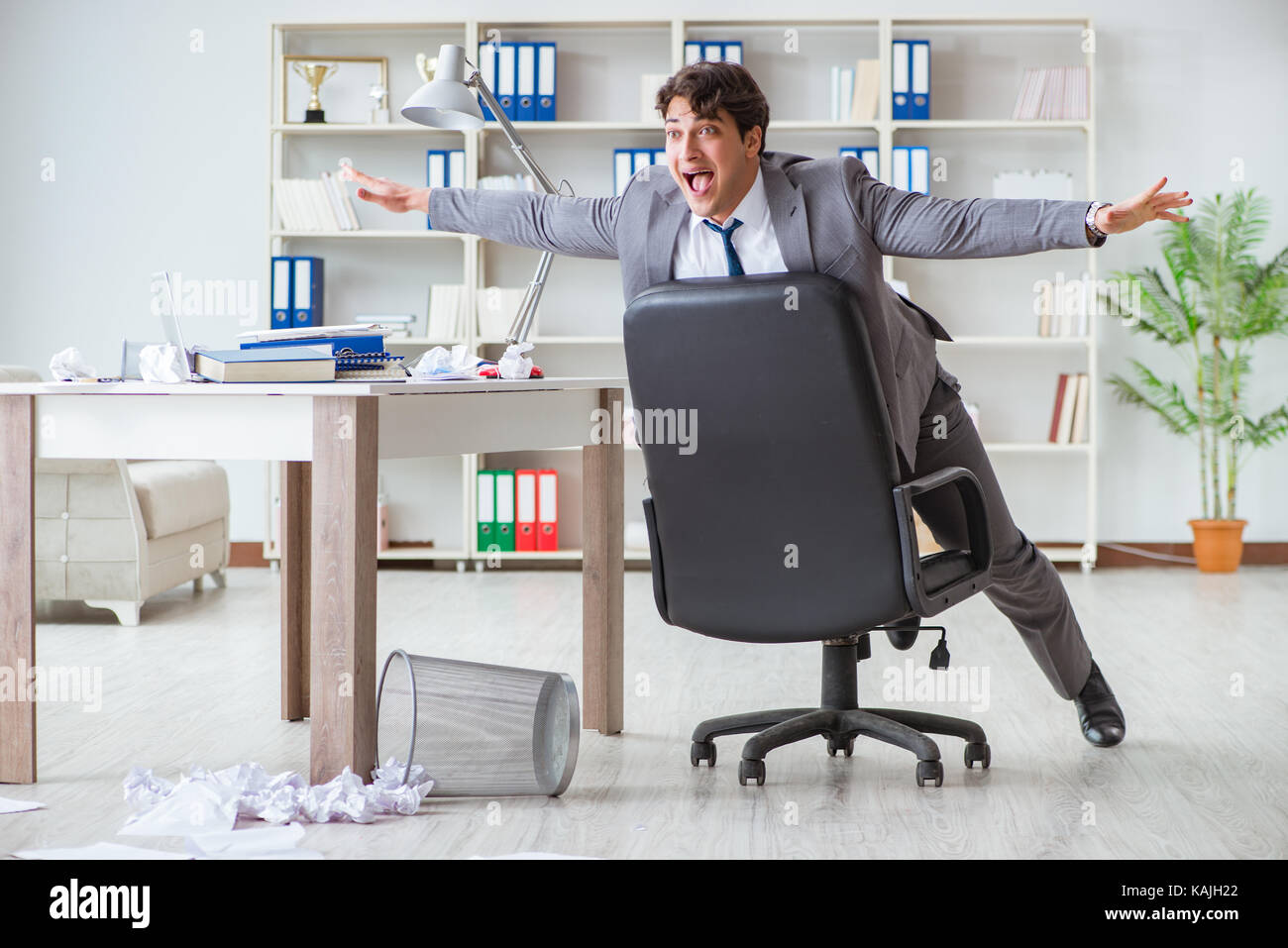 Businessman having fun taking a break in the office at work Stock Photo ...