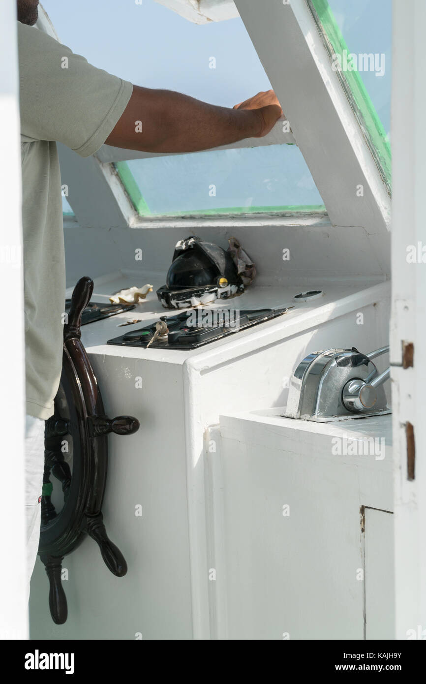 The captain controls the yacht. Sea adventures Stock Photo - Alamy