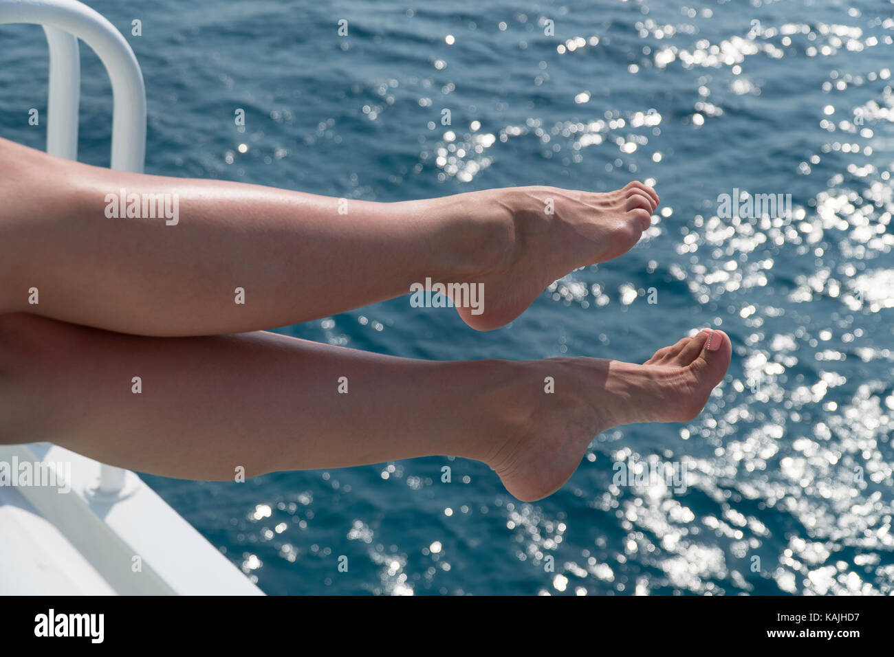 Young woman hanging legs over hi-res stock photography and images - Alamy
