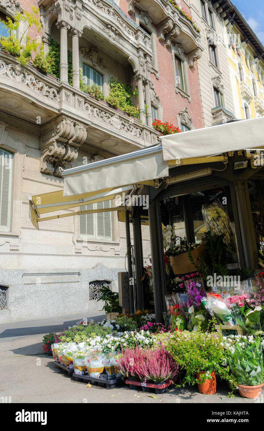 Flower shop in Milan, Lombardy, Italy. Also flowers on the balcony of a ...
