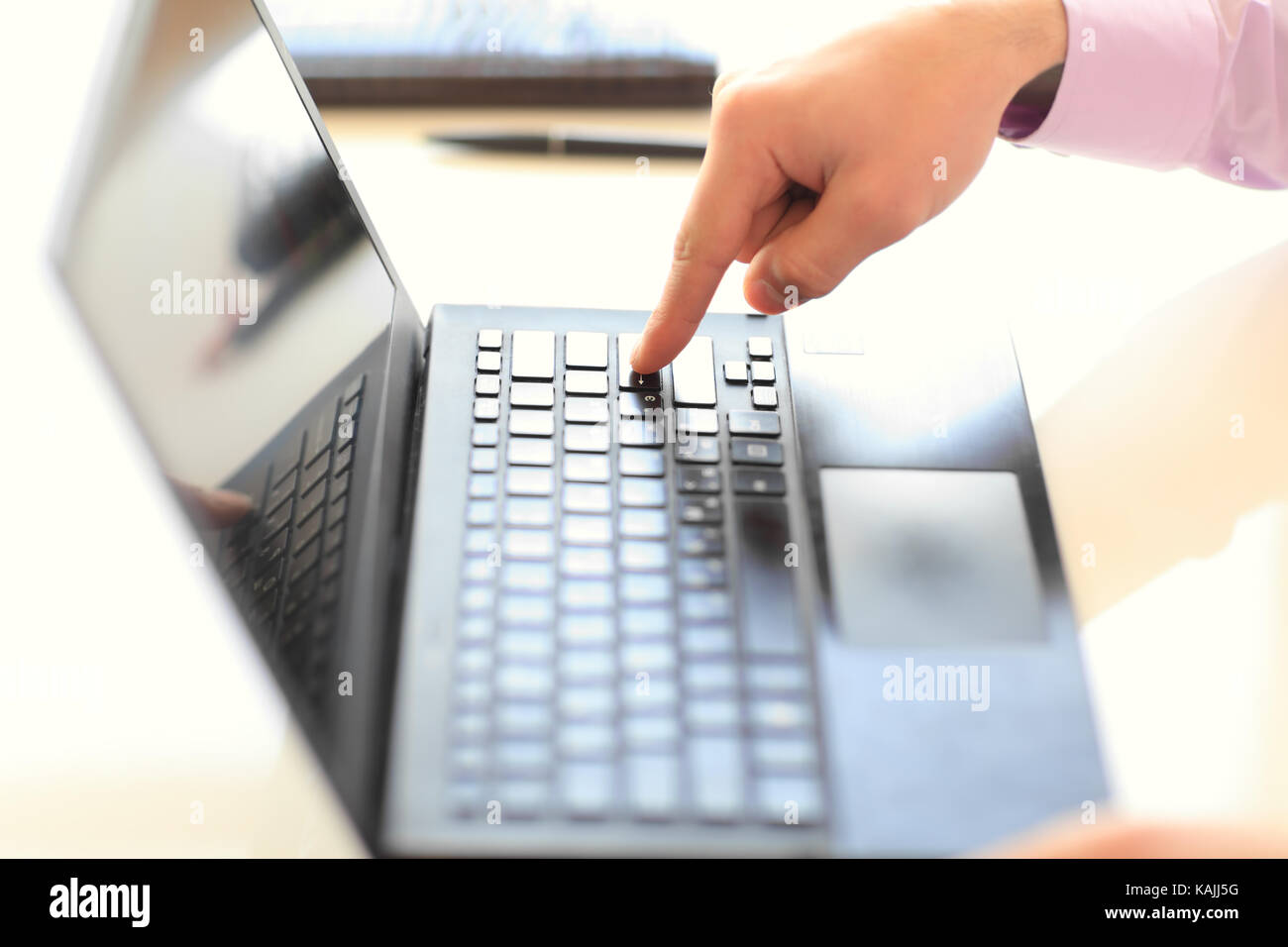 Businessman push "Enter" button on laptop keyboard Stock Photo - Alamy