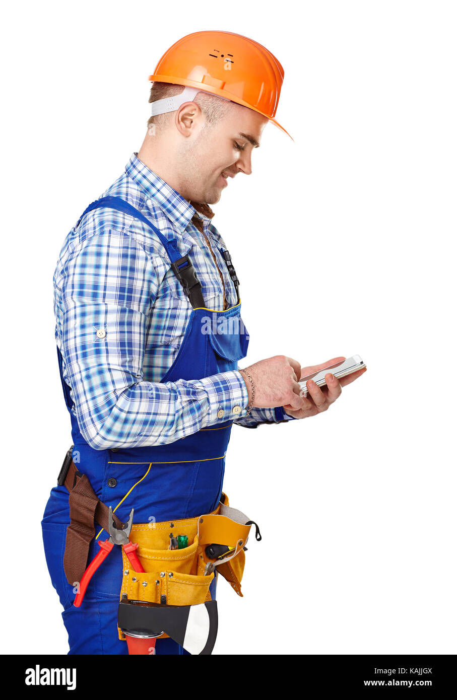 Side view portrait of young male construction worker with smartphone ...