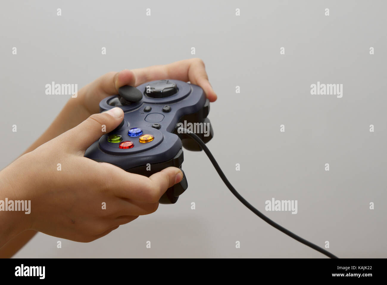 Young video gamer's hands using a gamepad. Cross-processing Stock Photo ...