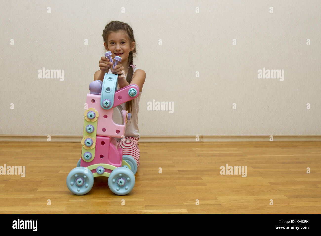 Seven-year-old girl playing with toys in the room Stock Photo - Alamy