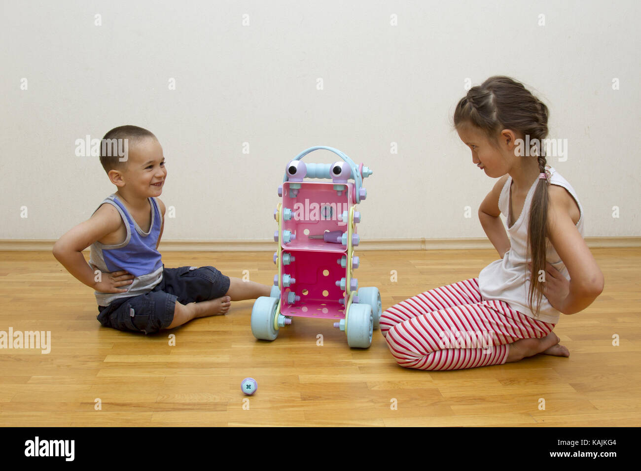 Brother and sister play with toys Stock Photo - Alamy
