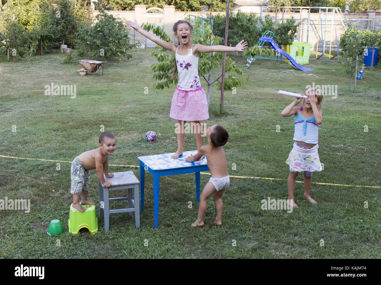 Four children play in the street on a summer day Stock Photo - Alamy
