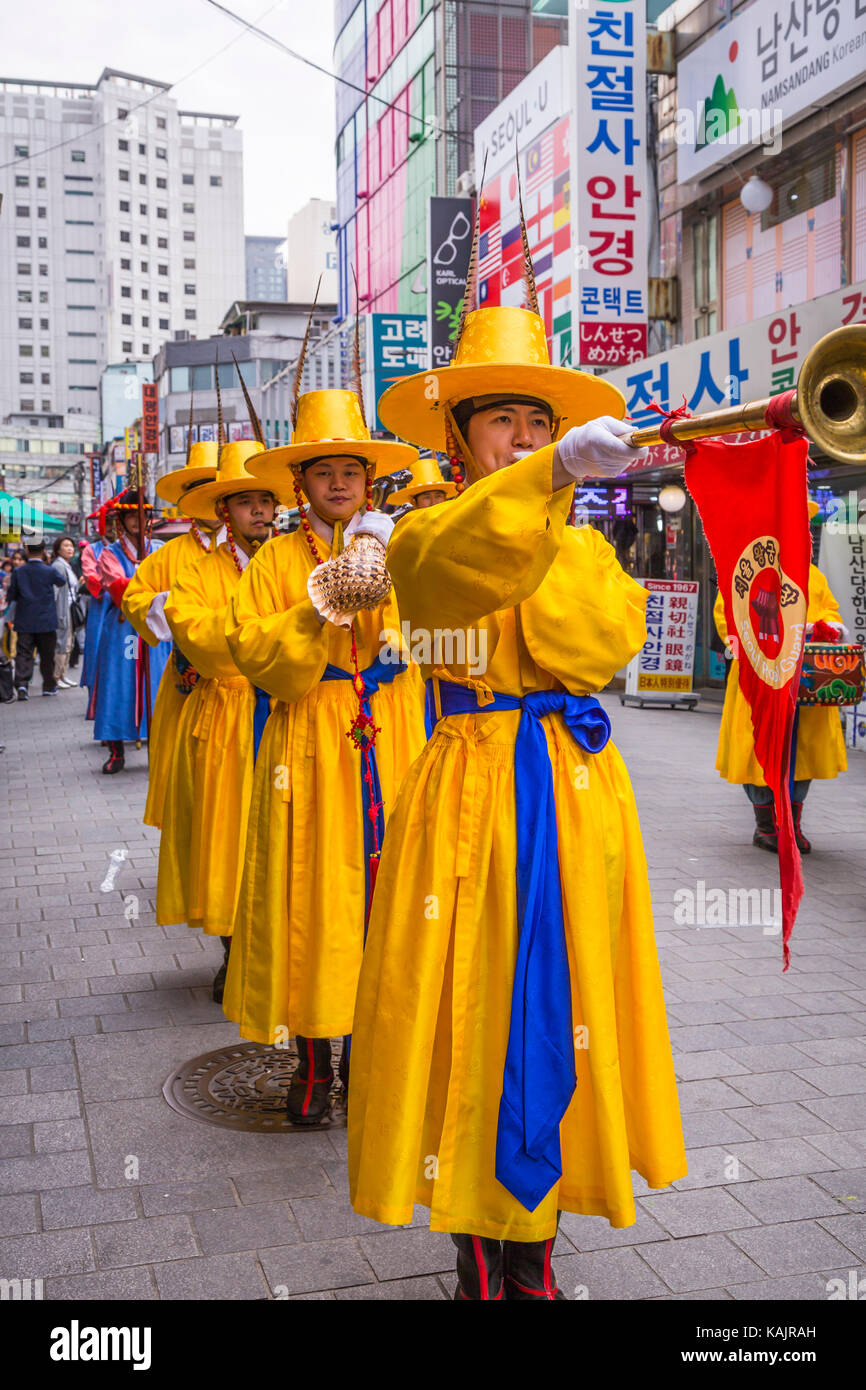 A traditional Korean music orchestra marching down the Namdaemun Market ...