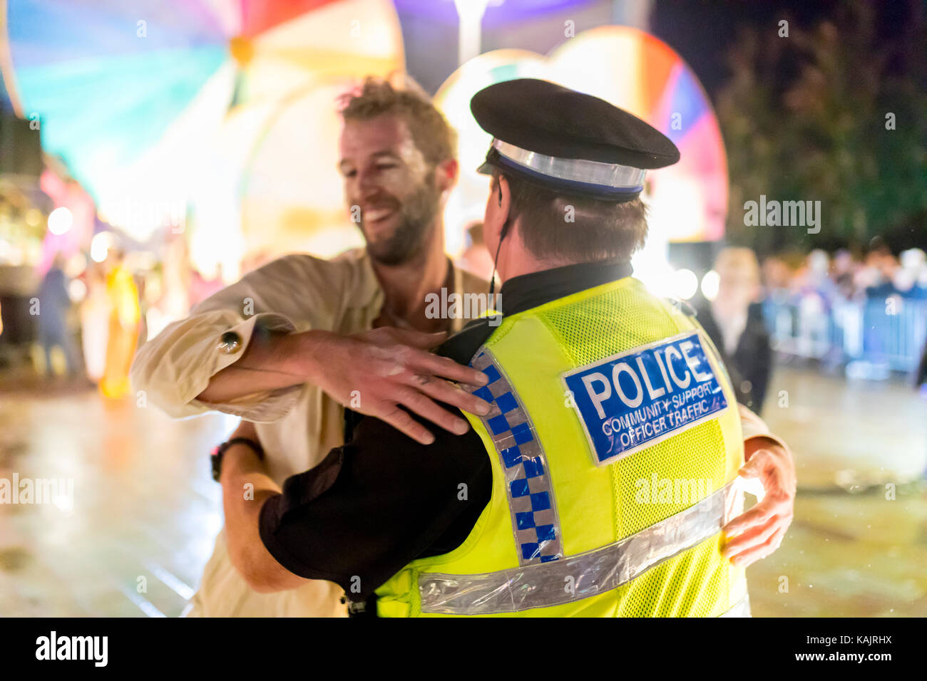 Colour of Light performer hugs a policeman during a performance in ...
