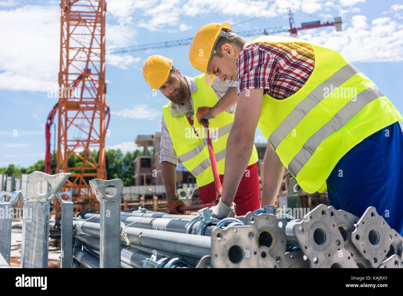 Two efficient blue-collar employees preparing supplies before building ...