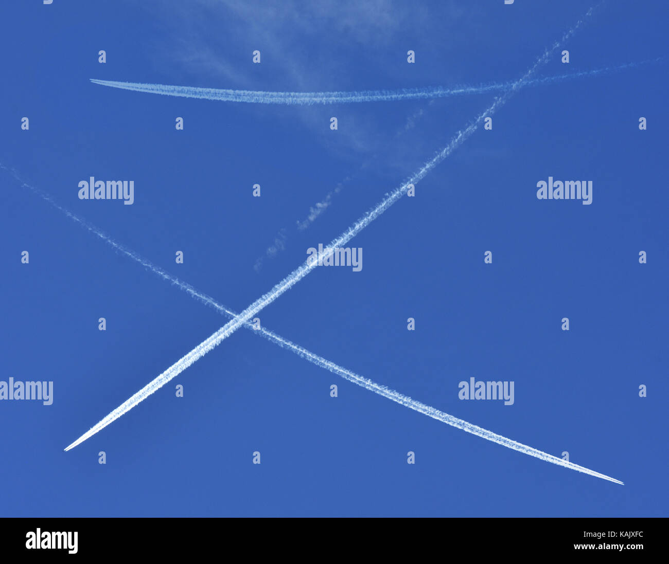 A jet plane flying overhead diagonally with condensation trail Stock ...