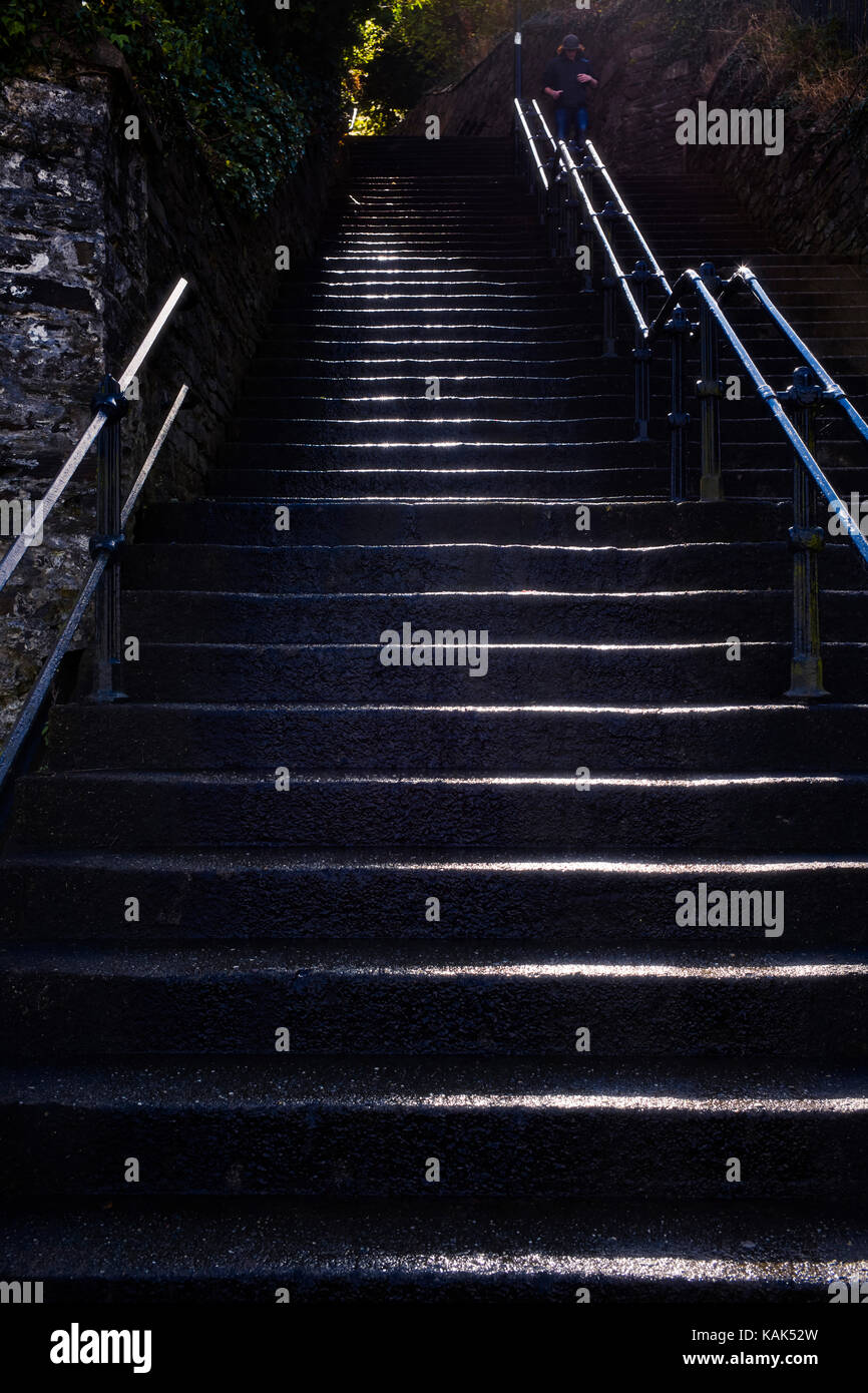 Steep steps with young man running down Stock Photo - Alamy