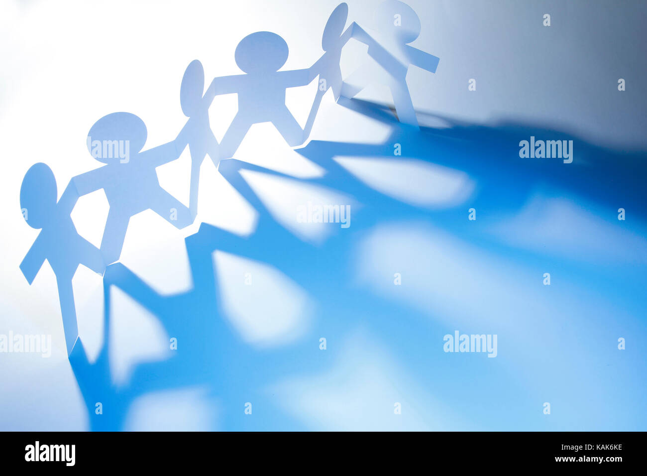 Team of paper chain people Stock Photo - Alamy