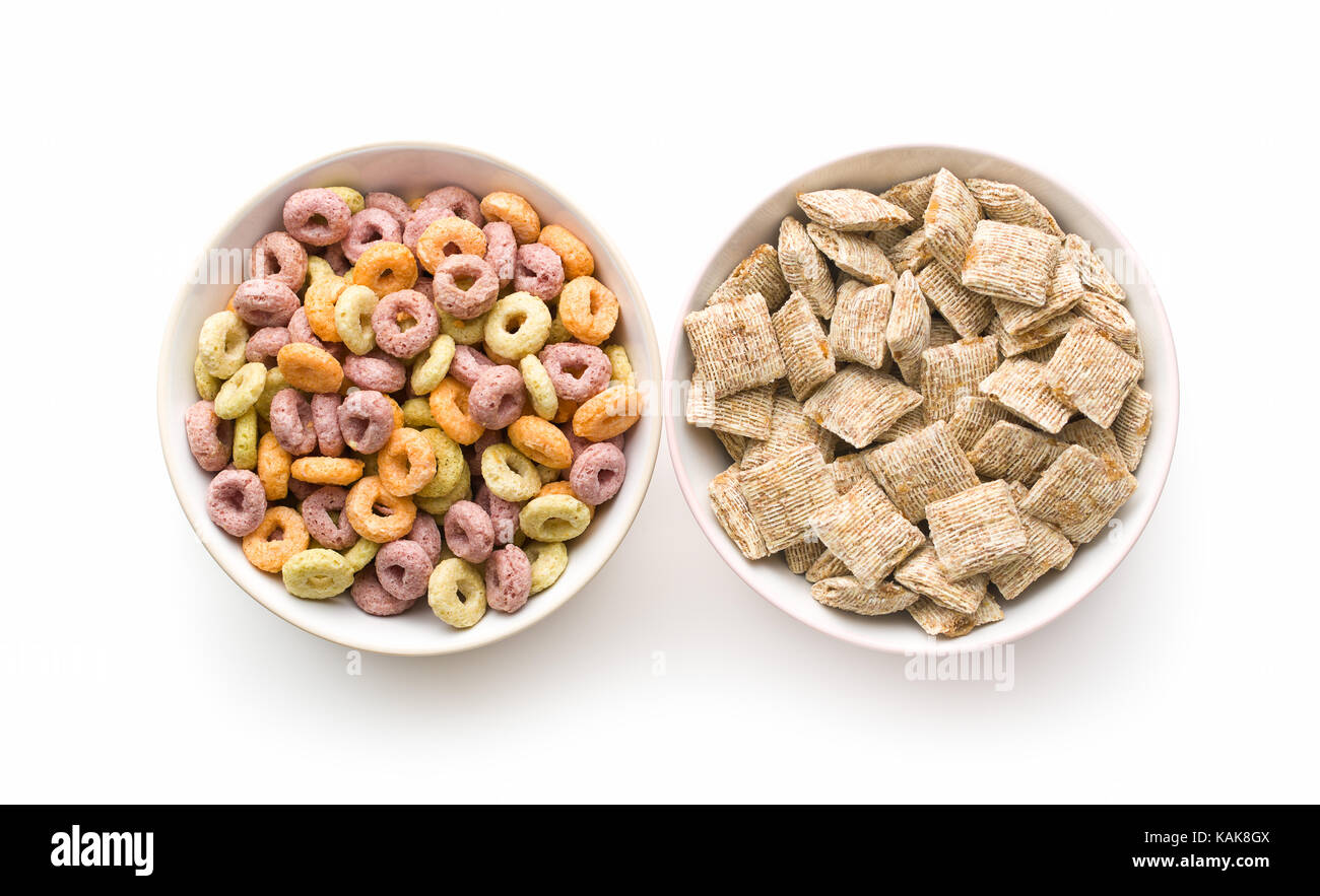 Breakfast cereal squares and rings in bowl isolated on white background ...
