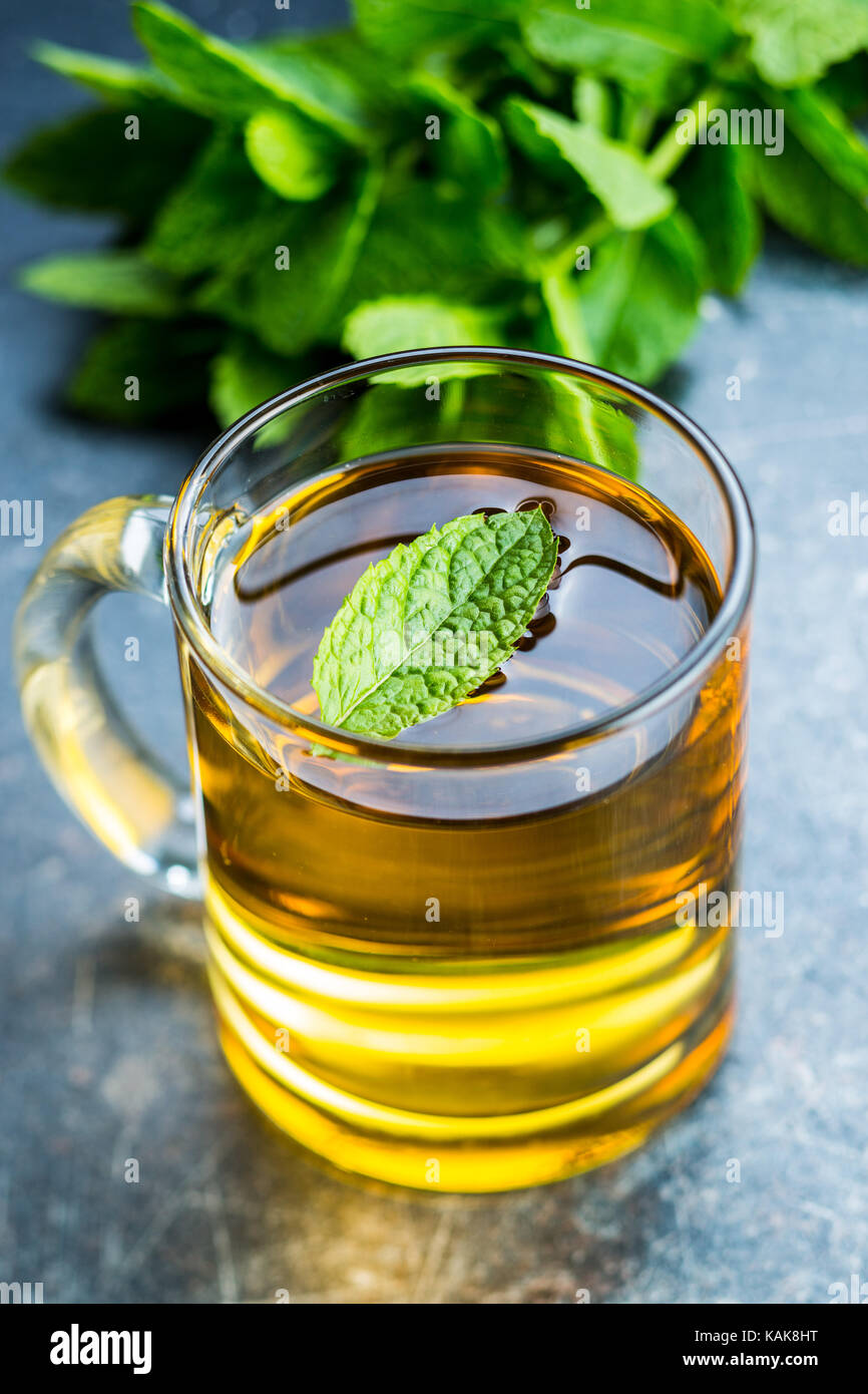 Tasty mint tea. Mint leaves and tea cup Stock Photo - Alamy