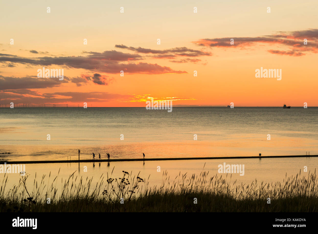 Walpole Bay.Cliftonville,Margate,Kent,UK. A family walking around a ...