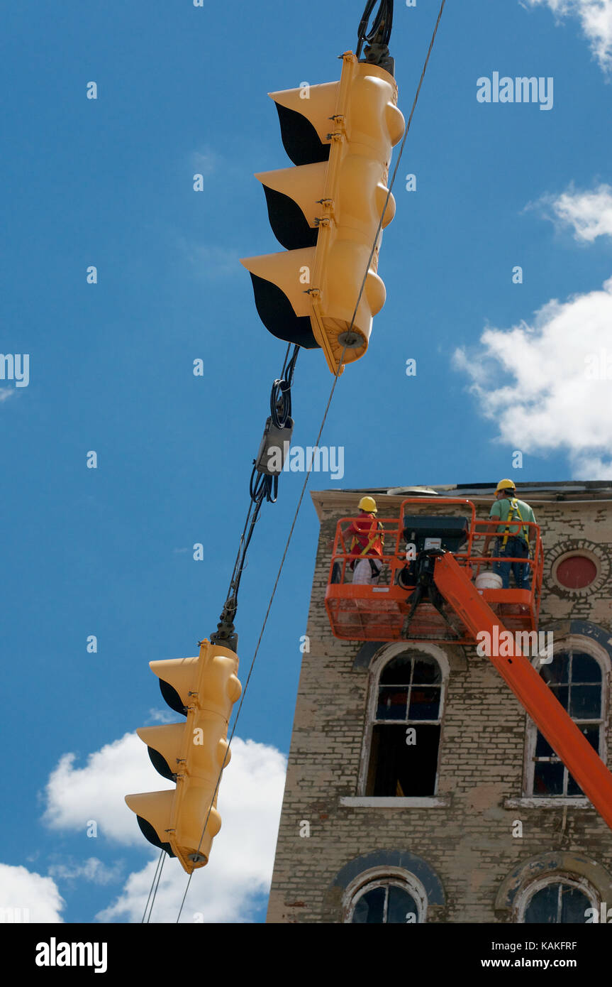 Men working on a building along with street traffic signals Stock Photo ...