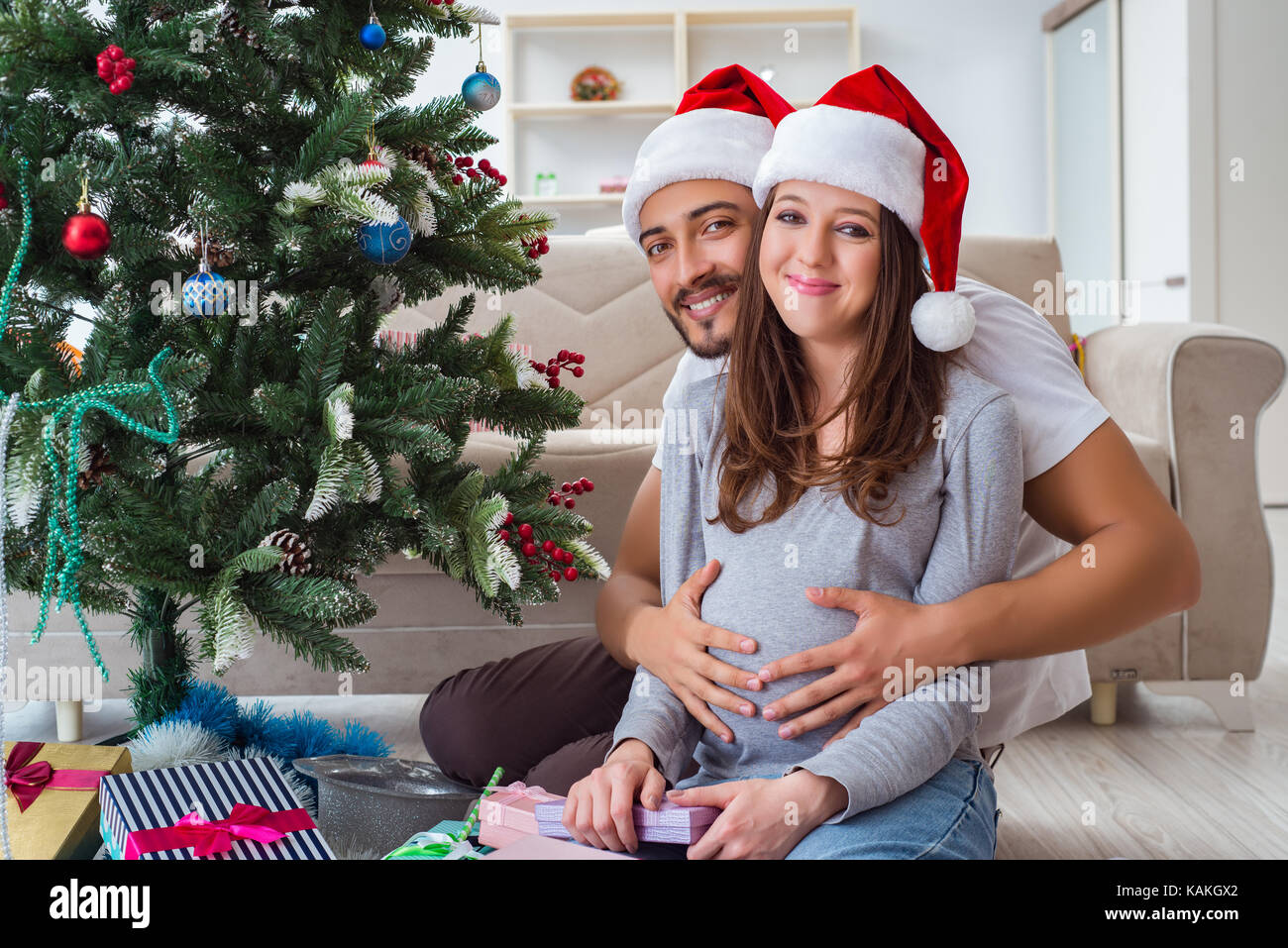 Young family expecting child baby celebrating christmas Stock Photo - Alamy