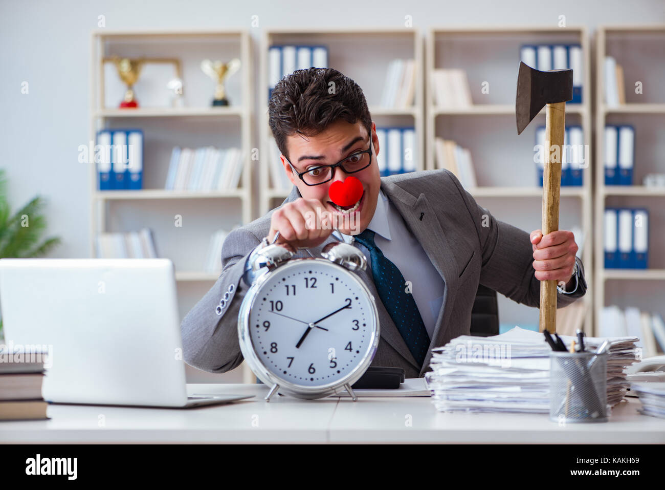 Clown businessman in the office with an axe and an alarm clock Stock ...