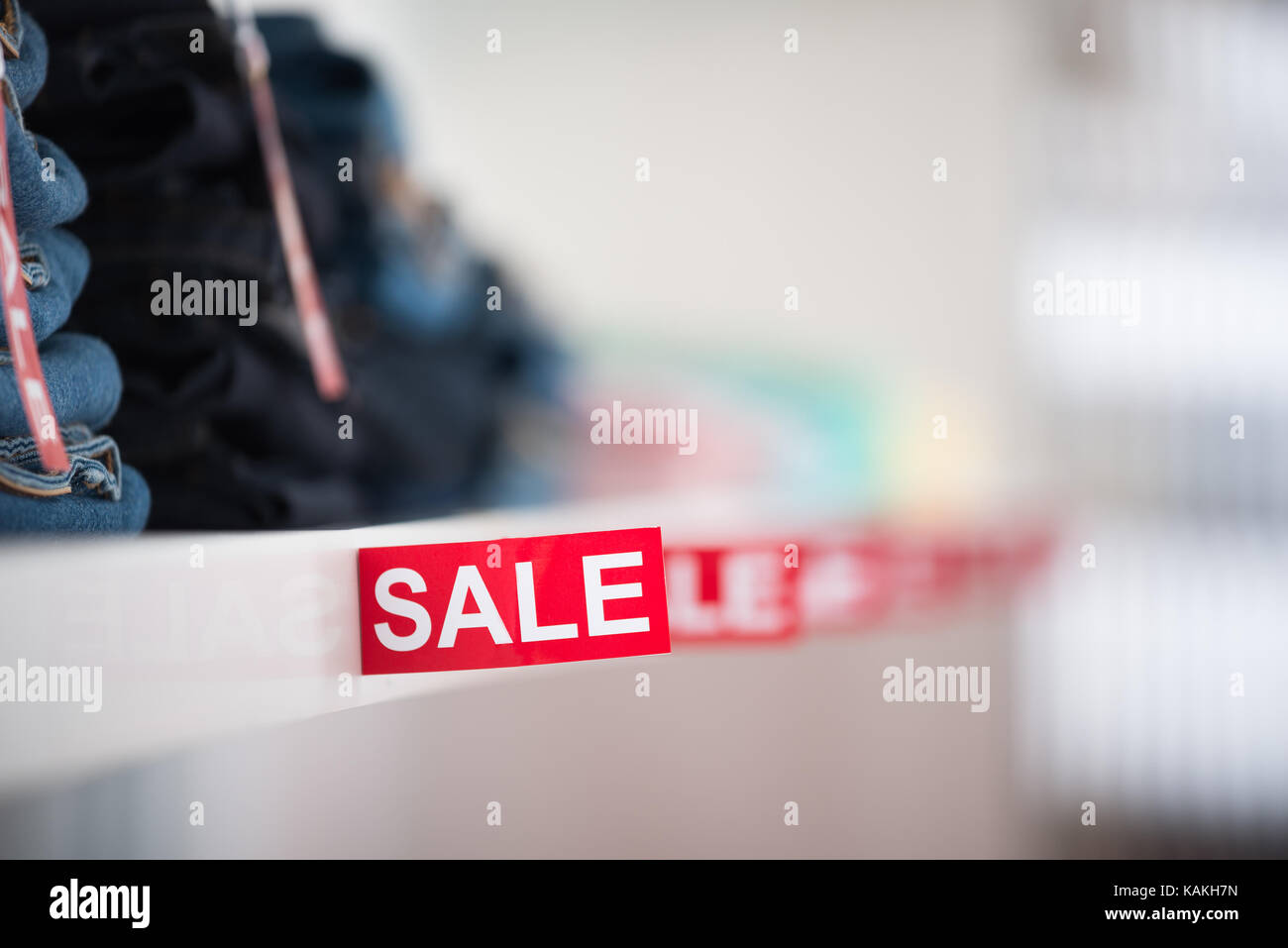 Closeup of sale sign on shelf at clothing store Stock Photo - Alamy