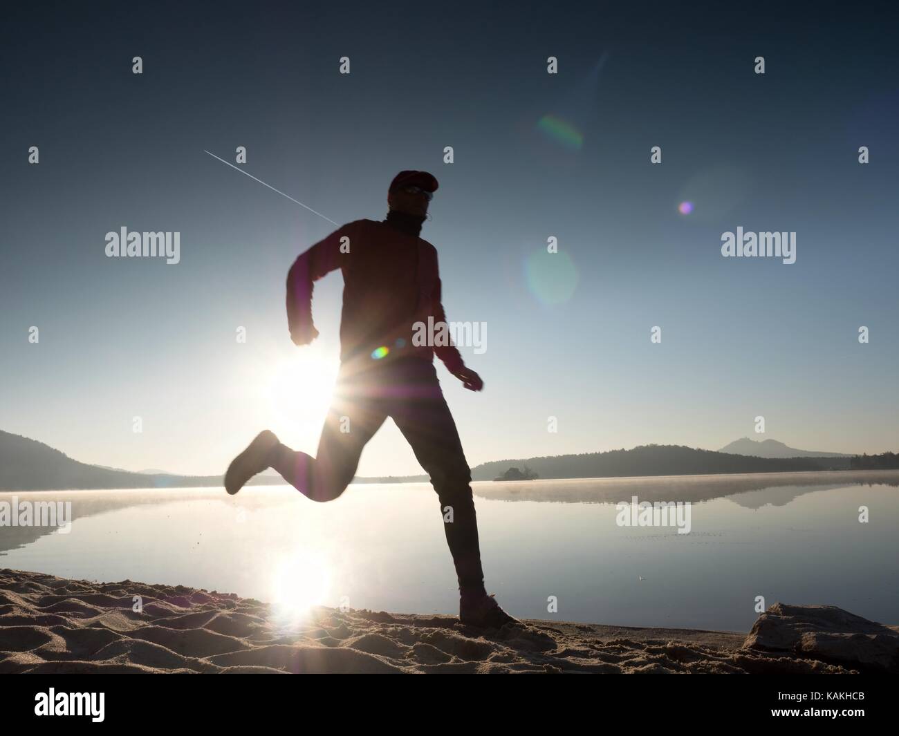 Running man. Boy quickly running on the morning beach. Sportsman runner ...