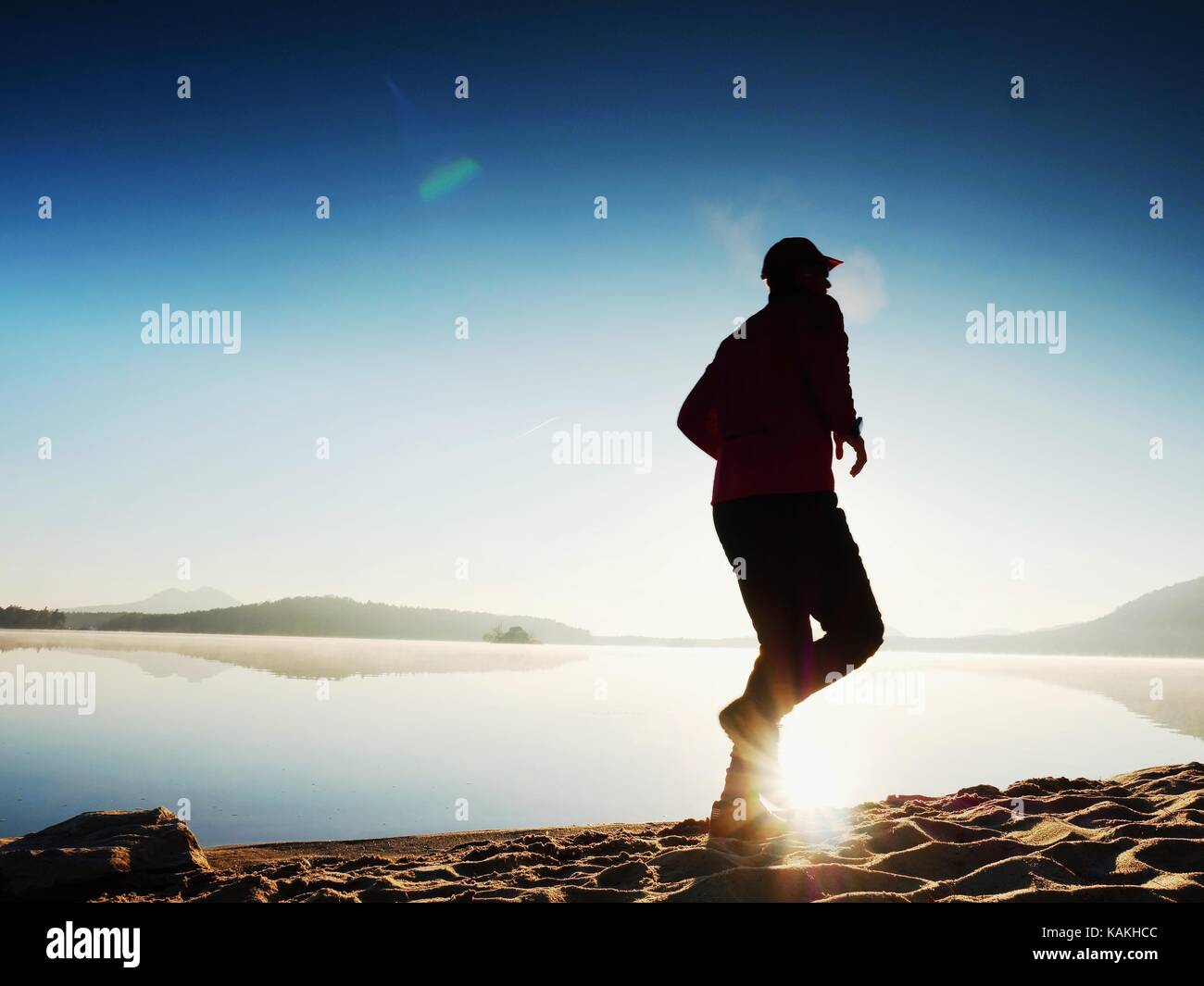 Running man. Boy quickly running on the morning beach. Sportsman runner ...