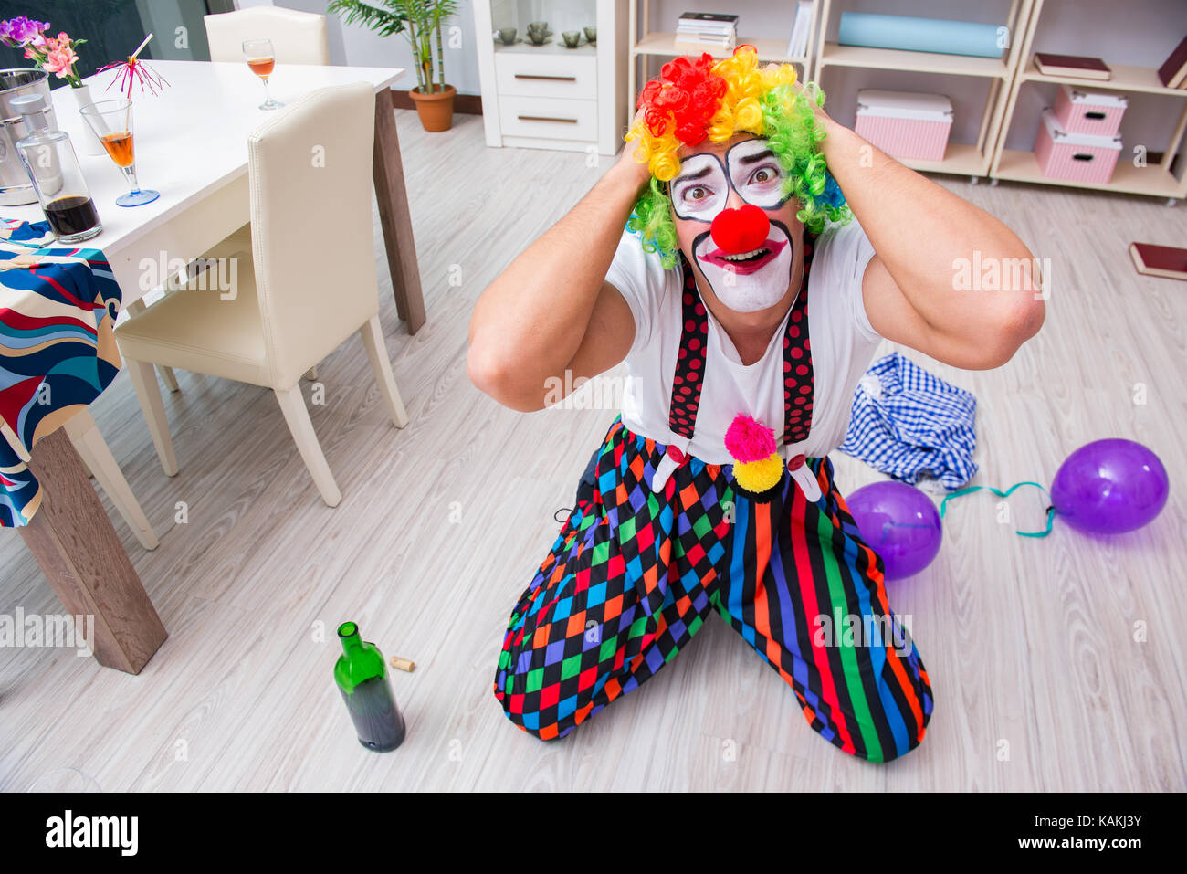 Drunk clown celebrating having a party at home Stock Photo - Alamy