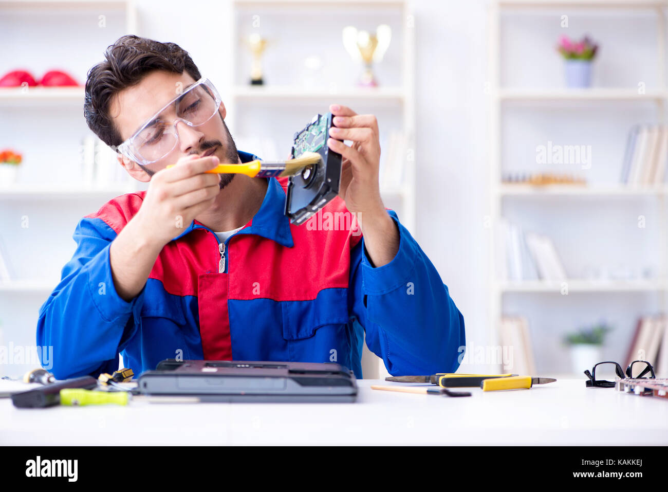 Repairman working in technical support fixing computer laptop ...