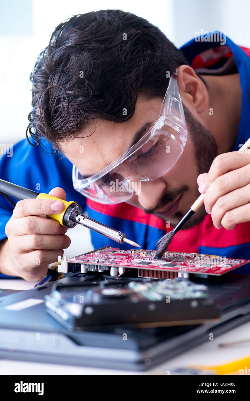 Repairman working in technical support fixing computer laptop ...