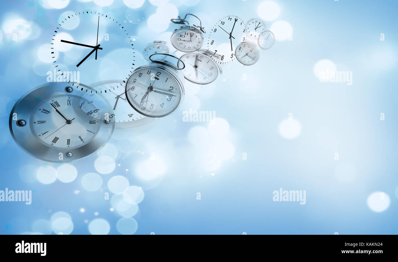 Assorted clocks on blue abstract background Stock Photo - Alamy