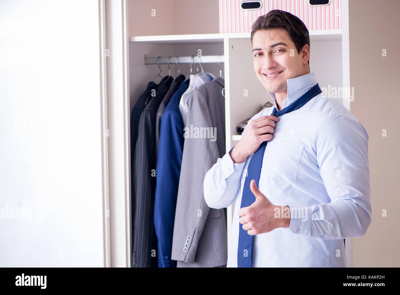 Young man businessman getting dressed for work Stock Photo - Alamy