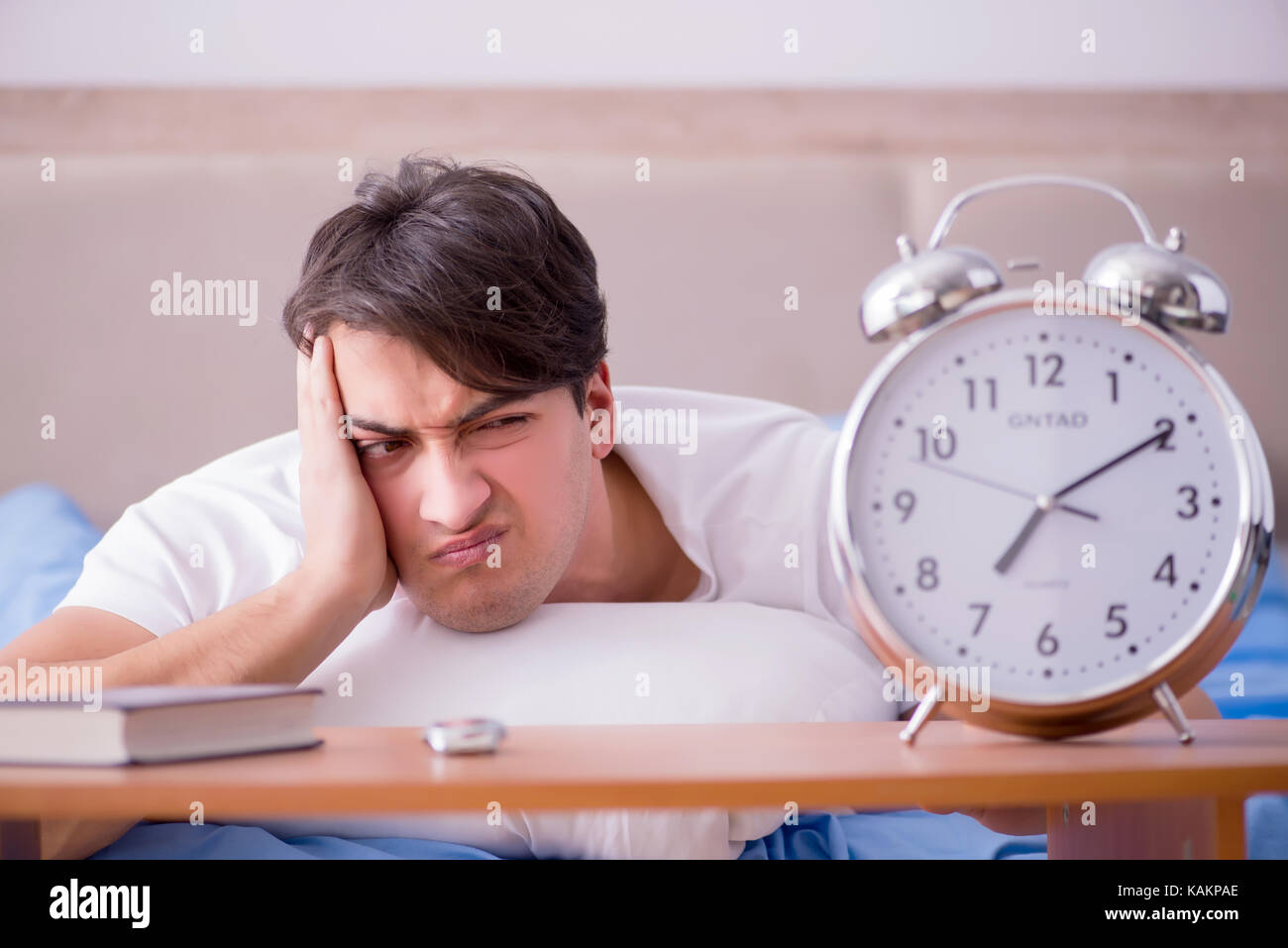 Man in bed frustrated suffering from insomnia with an alarm clock Stock ...