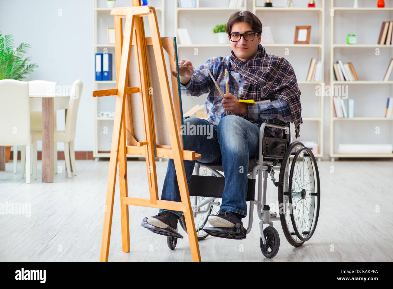 Disabled artist painting picture in studio Stock Photo - Alamy
