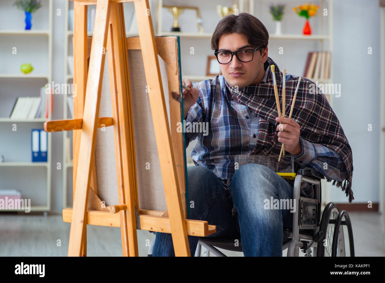 Disabled artist painting picture in studio Stock Photo - Alamy