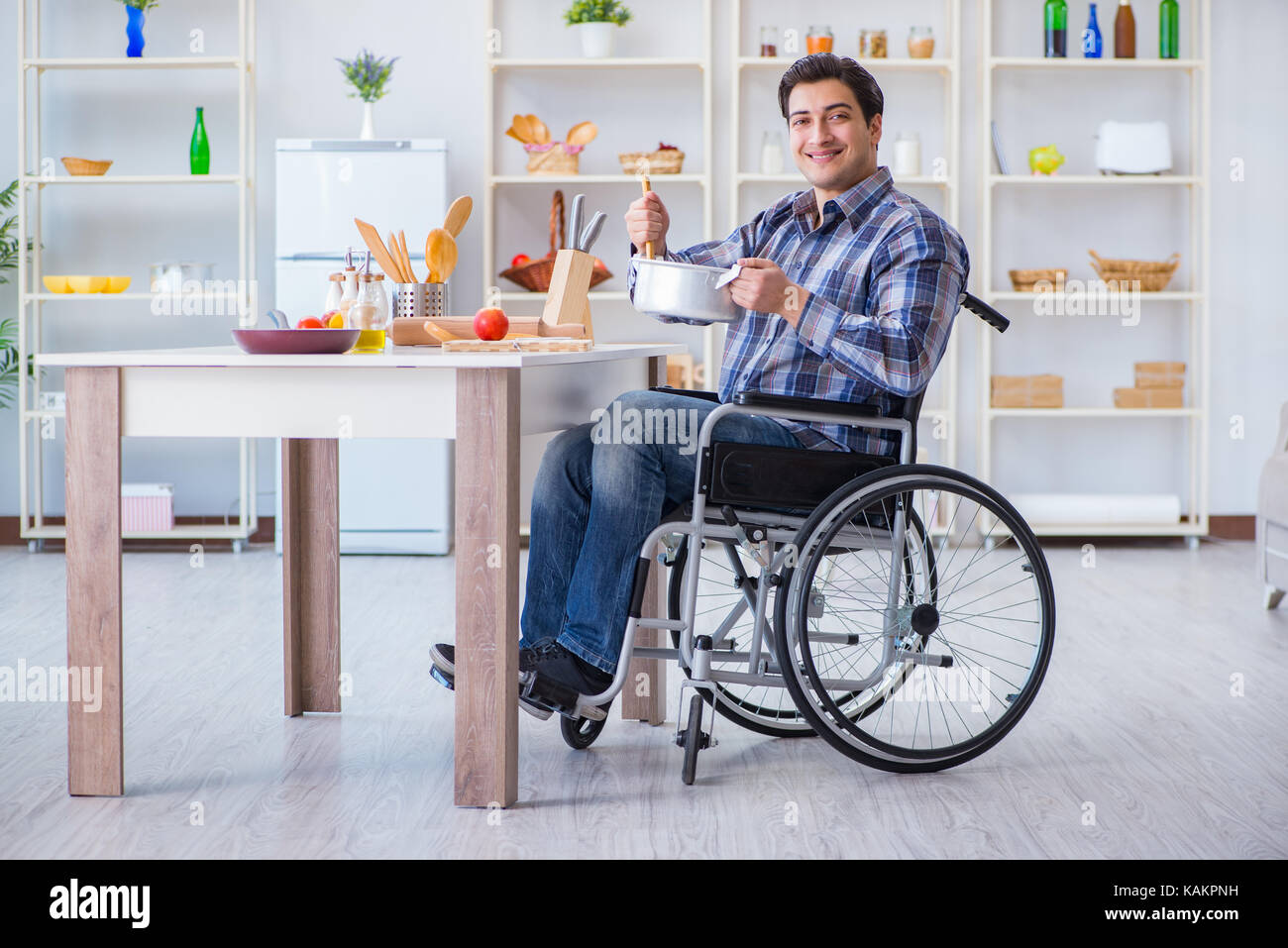 Disabled man preparing soup at kitchen Stock Photo - Alamy